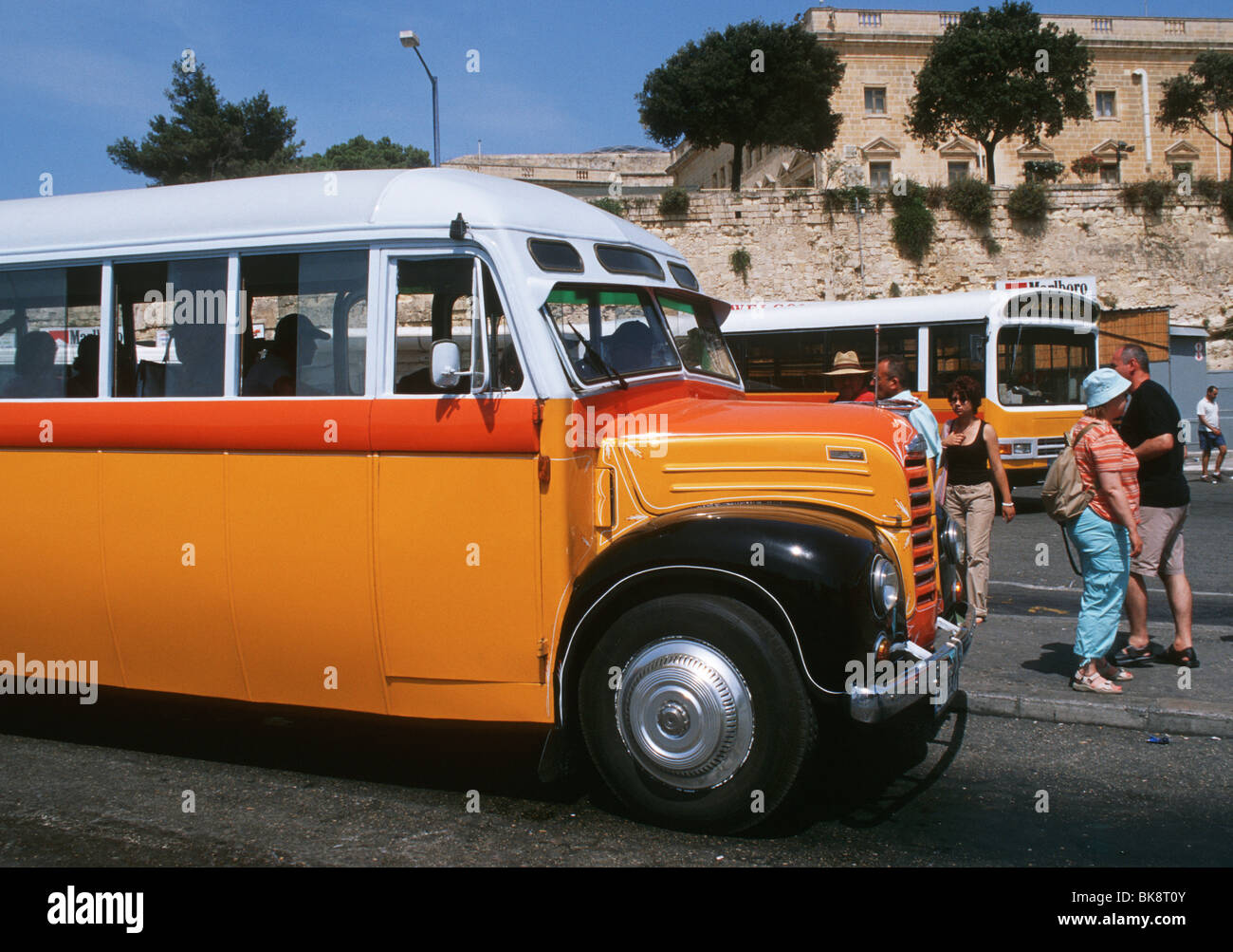 traditional Maltese buses and tourists, bus terminal, Valletta, Malta ...