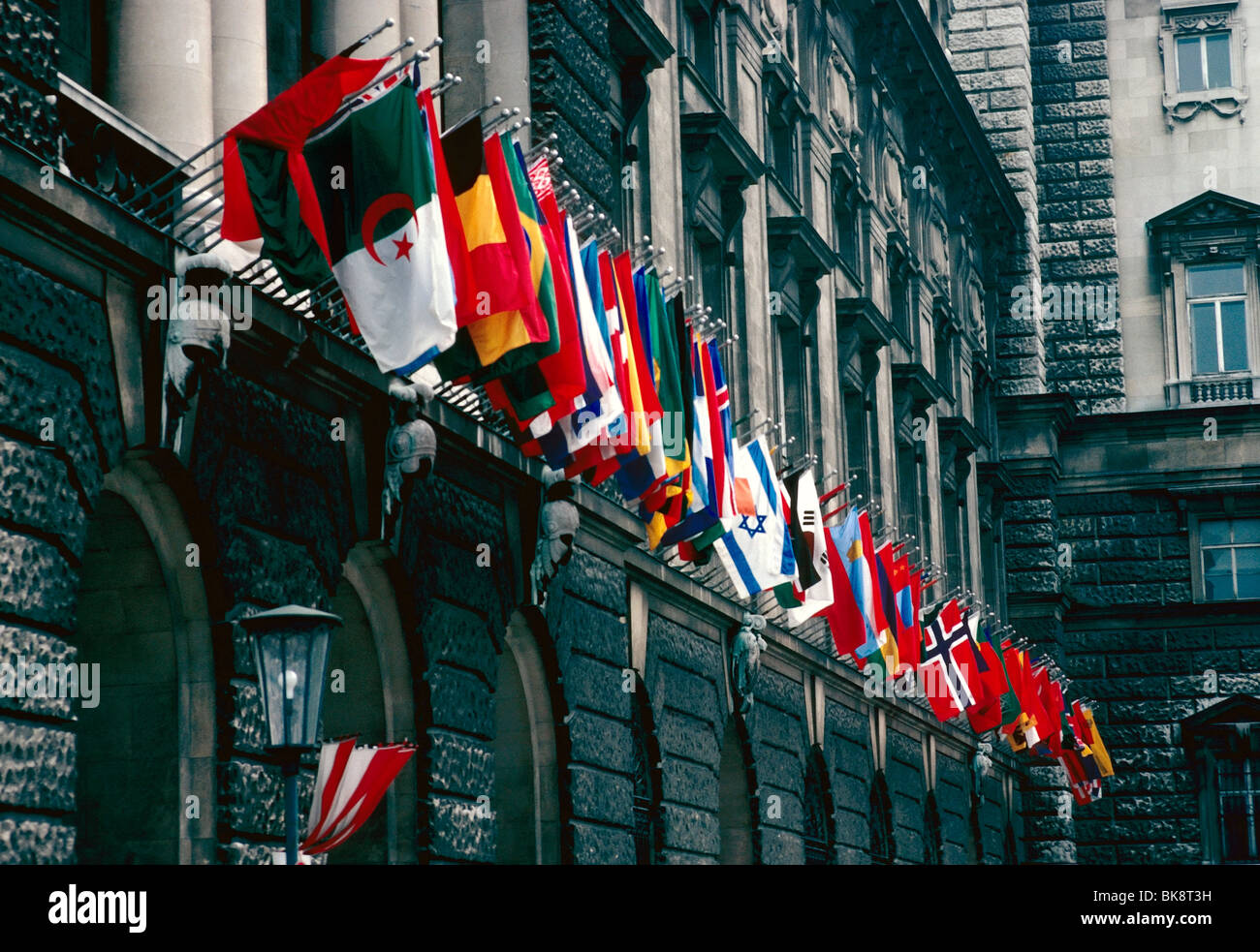 Multi national flags hanging in a row on a building facade, Vienna ...