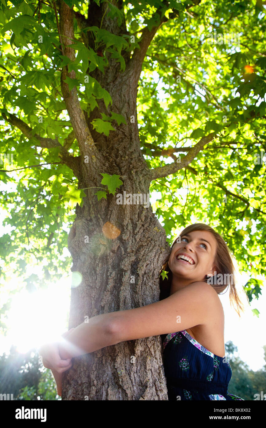 Girl hugging a tree Stock Photo - Alamy