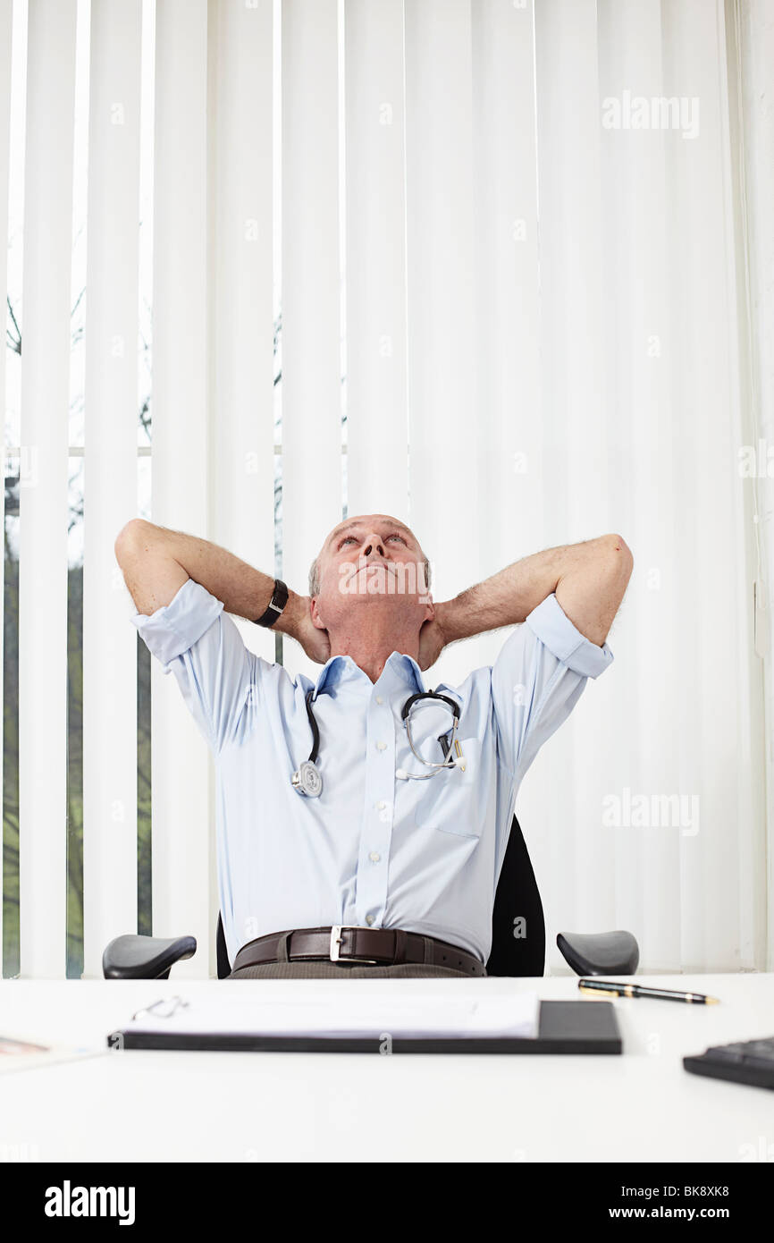 Doctor leaning back on chair hi-res stock photography and images - Alamy