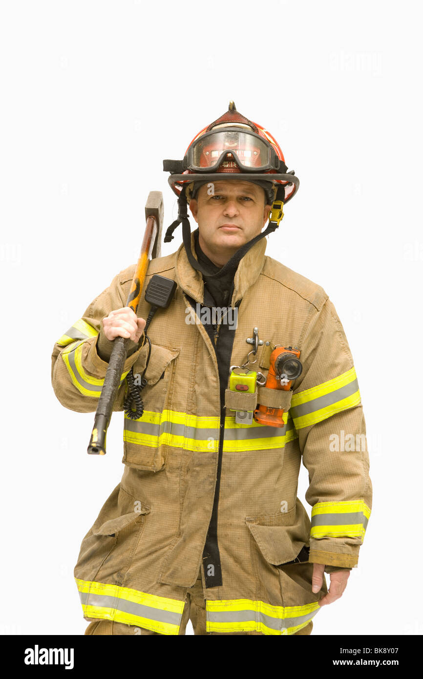 Fireman standing with an axe Stock Photo - Alamy