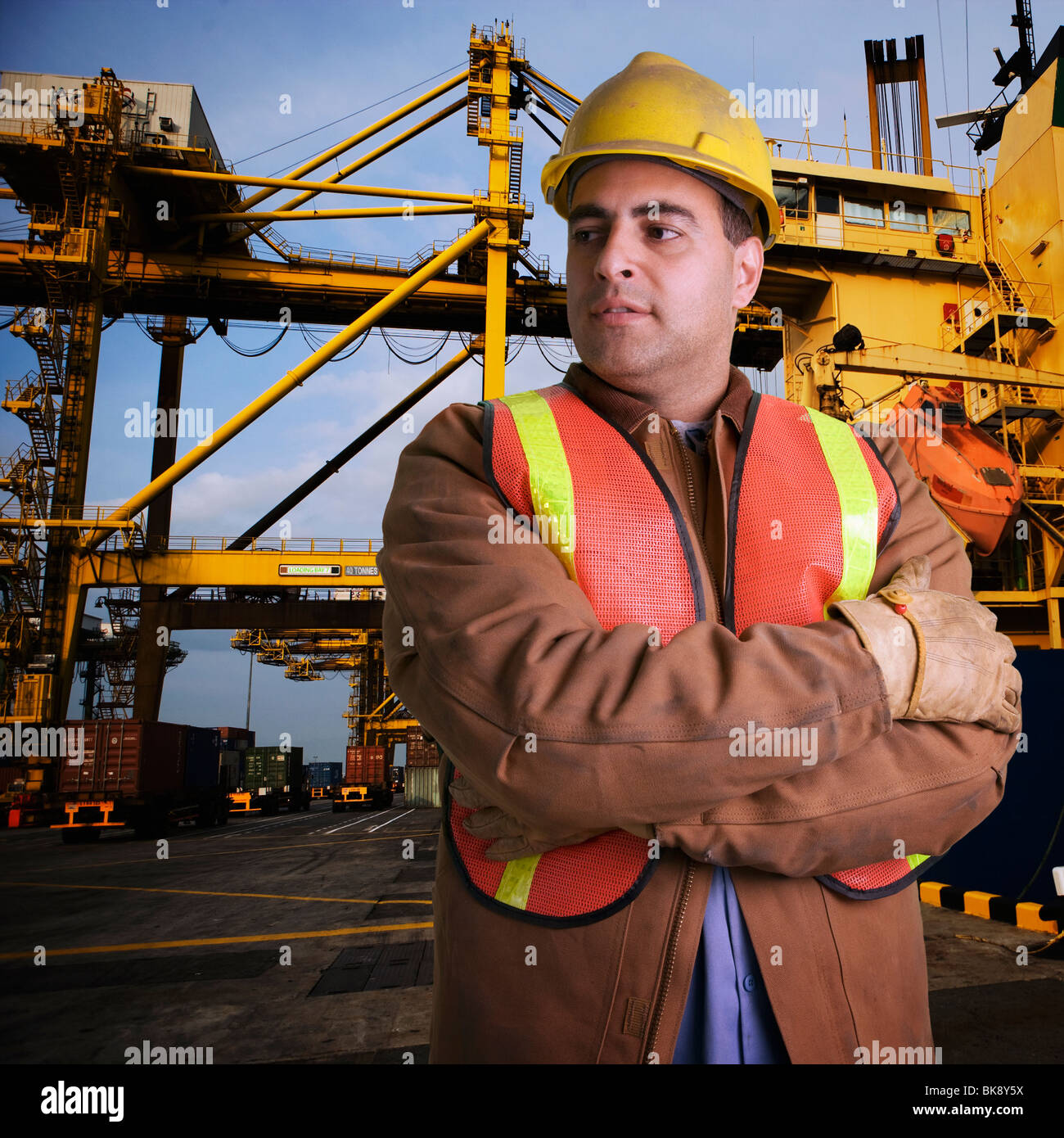 Dock worker standing at a commercial dock Stock Photo - Alamy