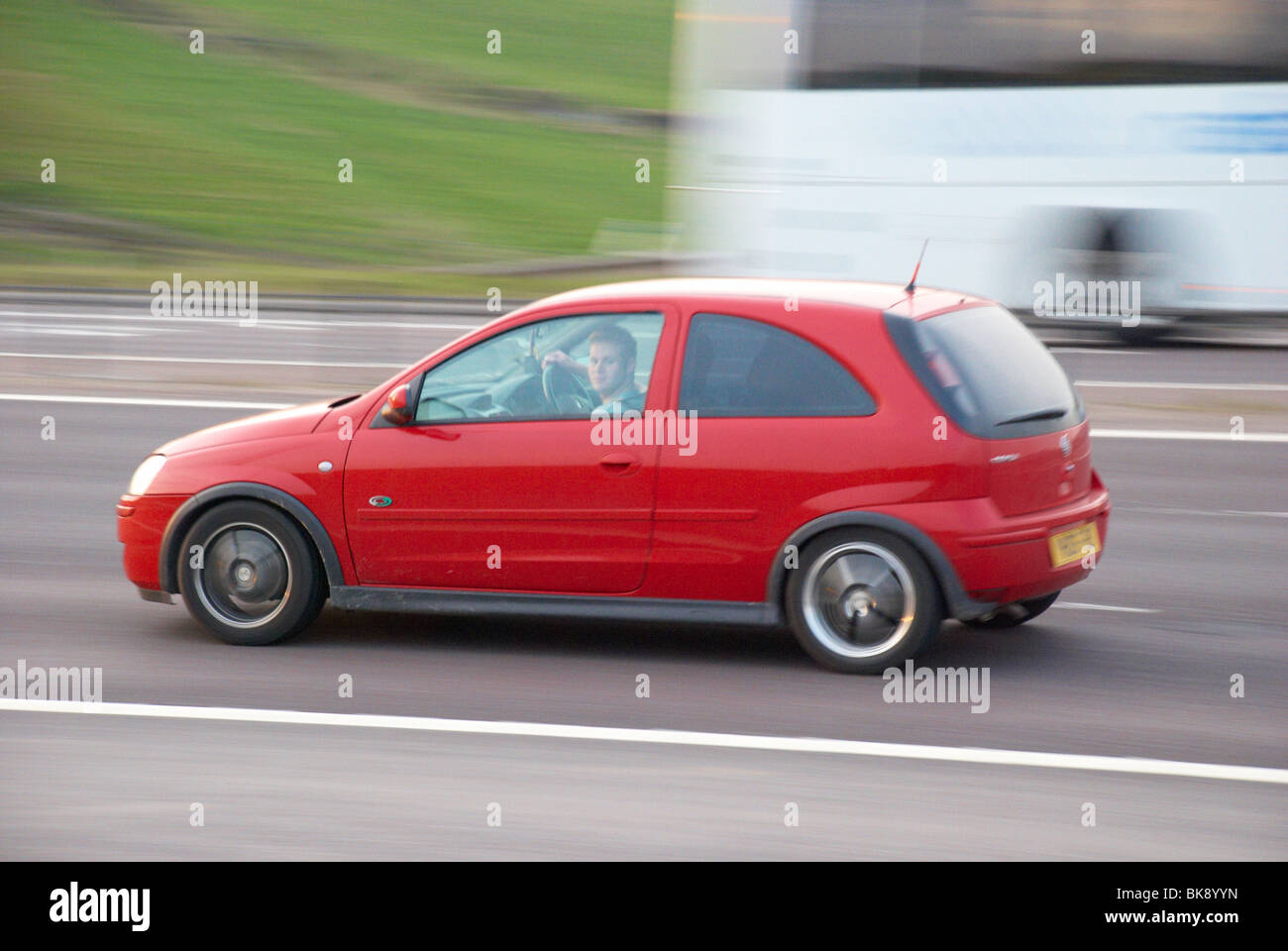 Small red car on the M62 Stock Photo - Alamy