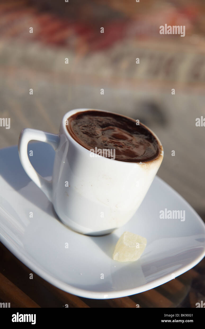 Real turkish coffee in a small white porcelain cup with a traditional ...