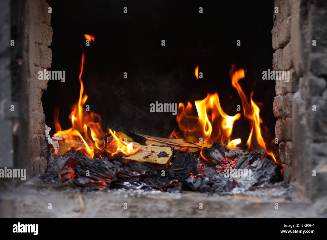 Burning ghost money for good luck at the Buddhist temple, Zhong Xiao ...