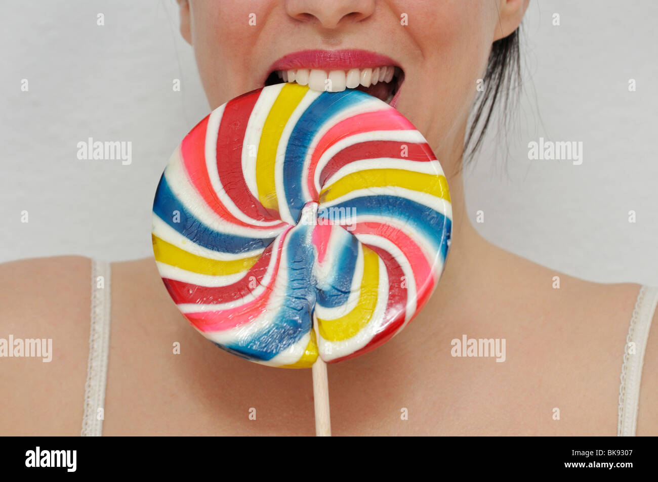 Woman biting lollipop hi-res stock photography and images - Alamy