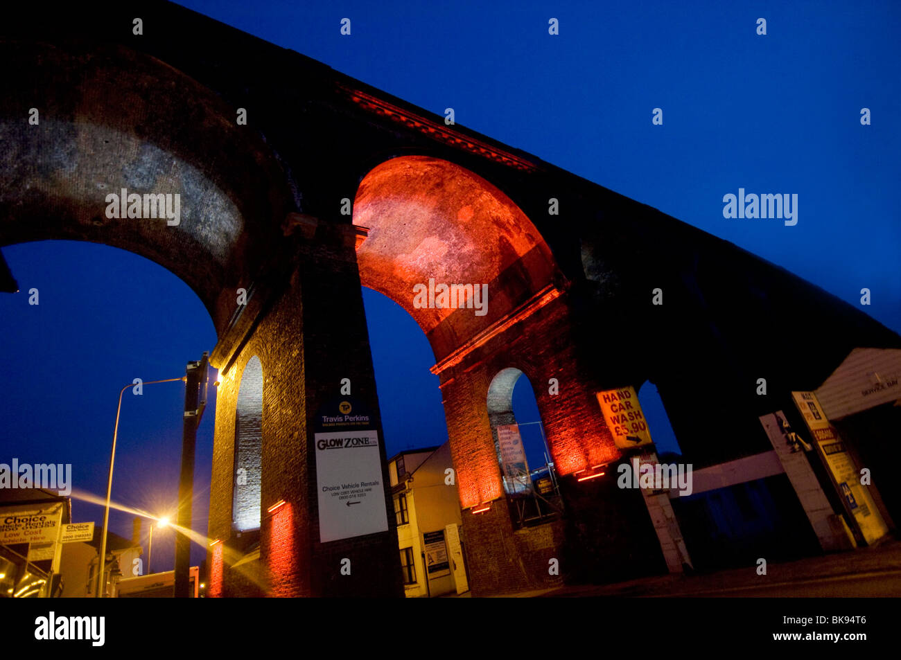 An old railway viaduct arch illuminated at night by the Railway ...