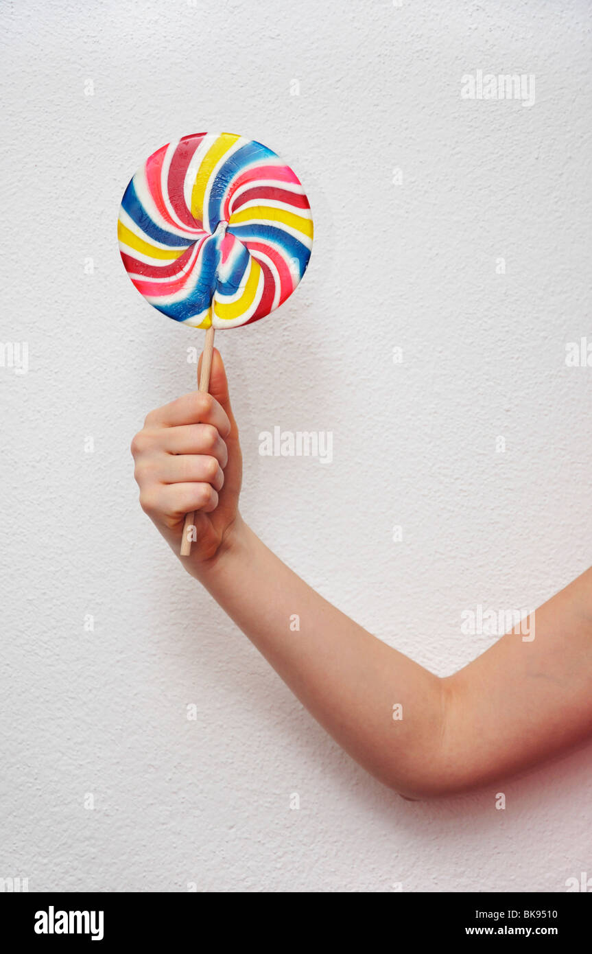 Hand holding lollipop Stock Photo - Alamy