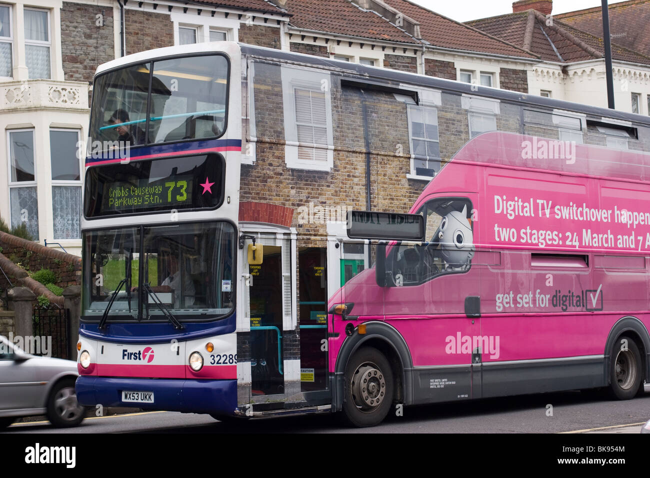A bus with a digital TV switchover advert all over it, blends into ...