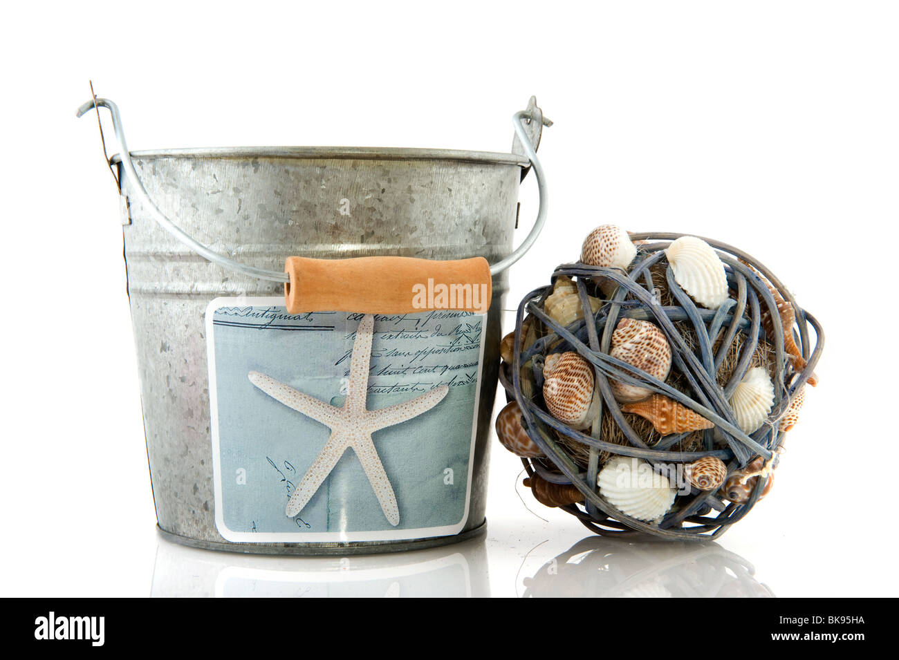 Zinc beach bucket with a ball shells Stock Photo - Alamy