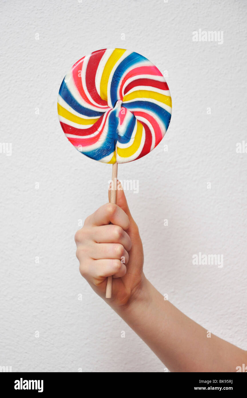 Hand holding lollipop Stock Photo - Alamy