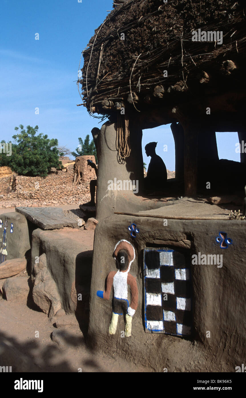 A Dogon man listening to a radio by the "to guna" (or casa palaver) at ...