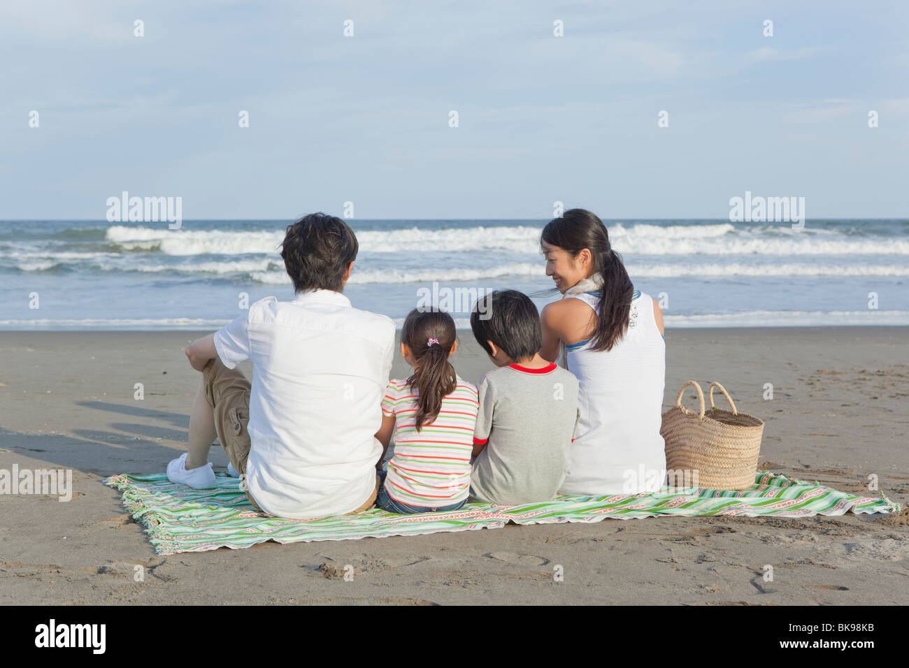 Family Sitting at Beach Stock Photo - Alamy