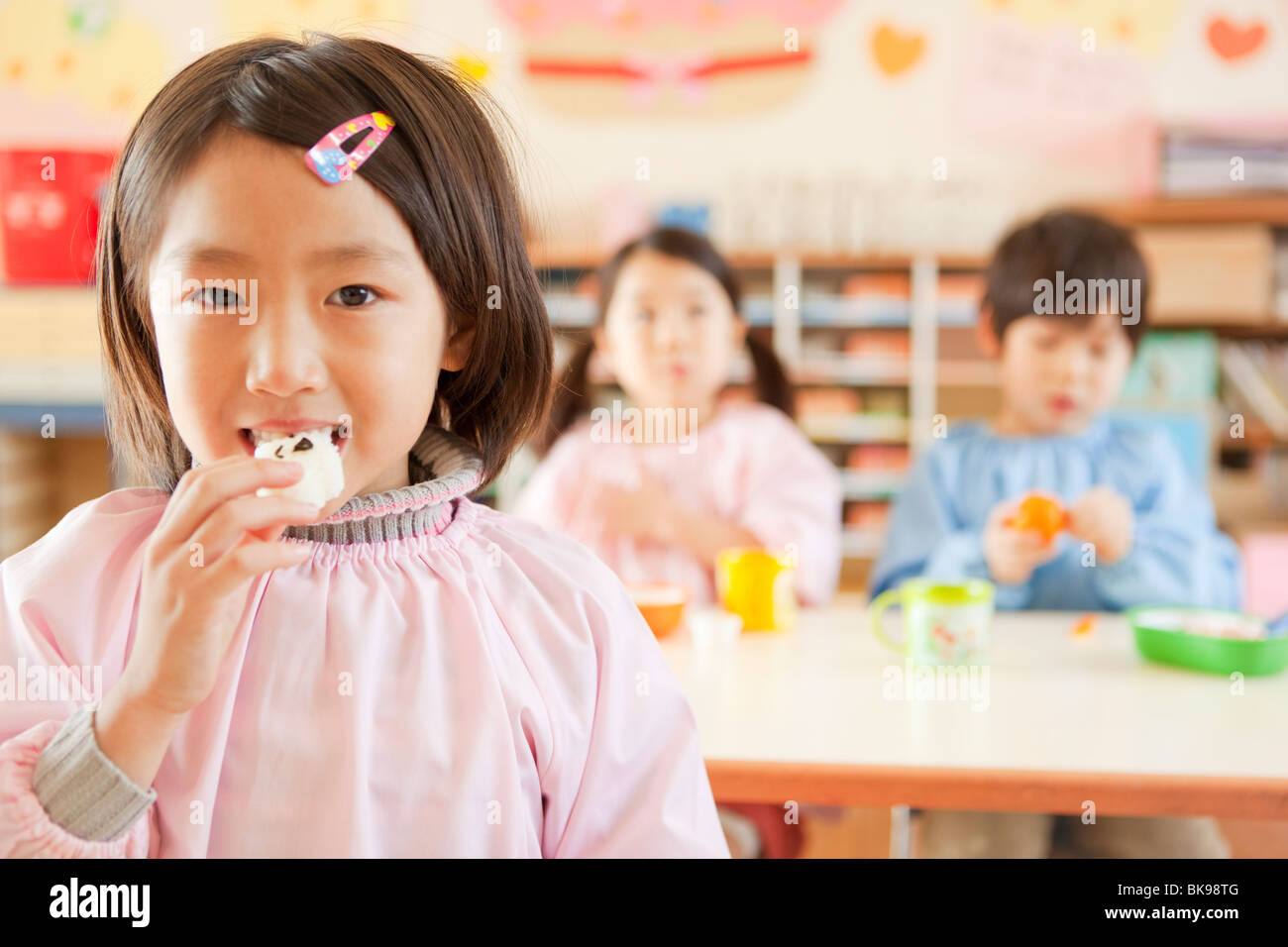 Kindergarten Girl Eating Rice Ball Stock Photo - Alamy