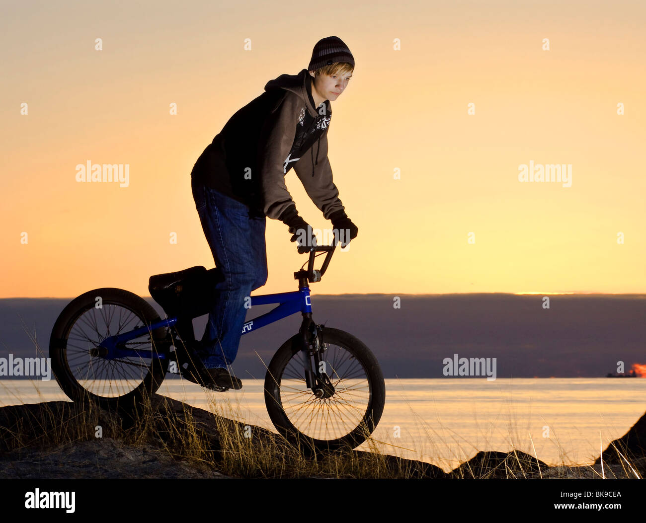 Boy riding bike, cycling in the night Stock Photo - Alamy