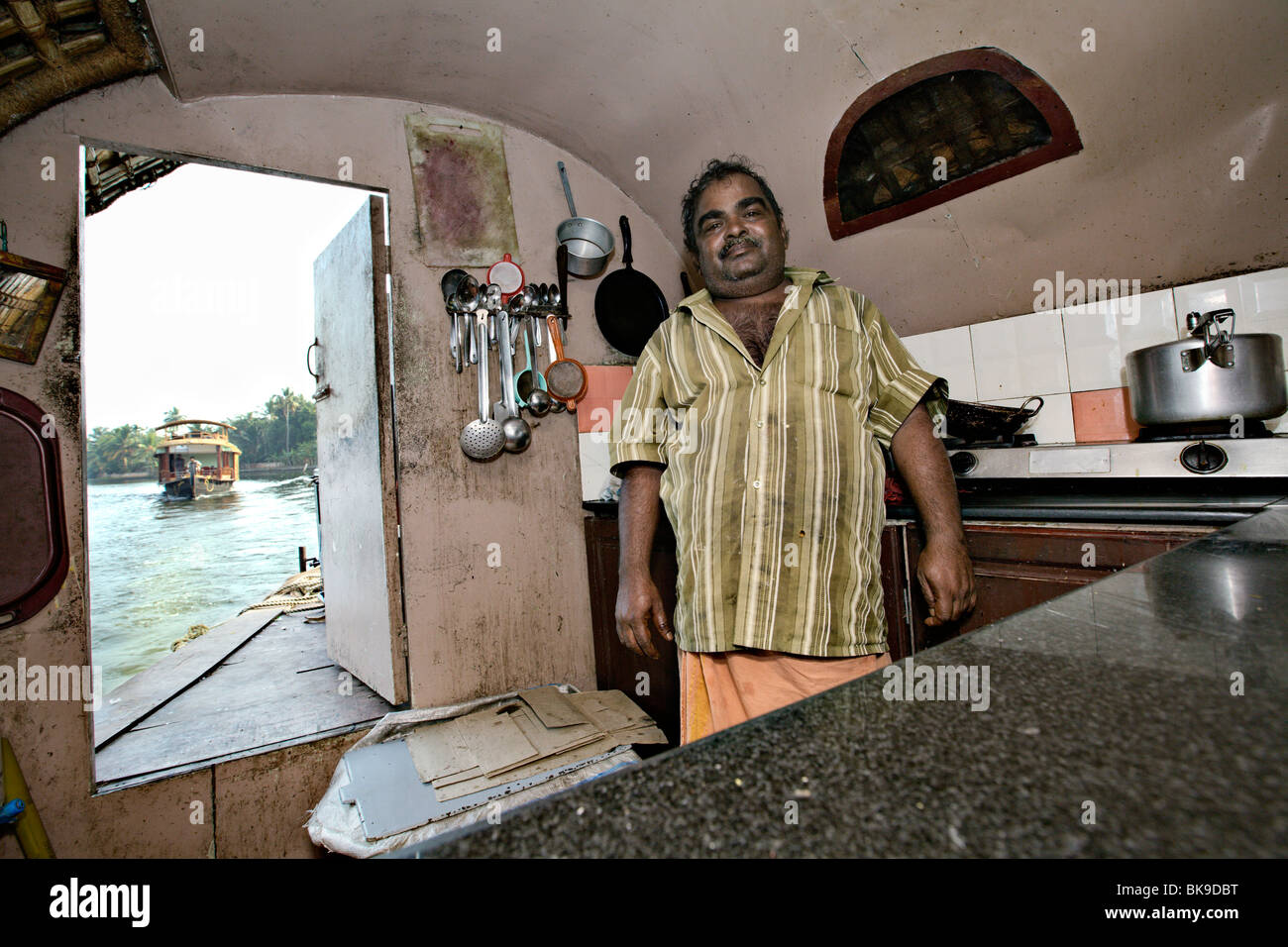 Chef in his houseboat kitchen on a backwater cruise in Kerala, India ...