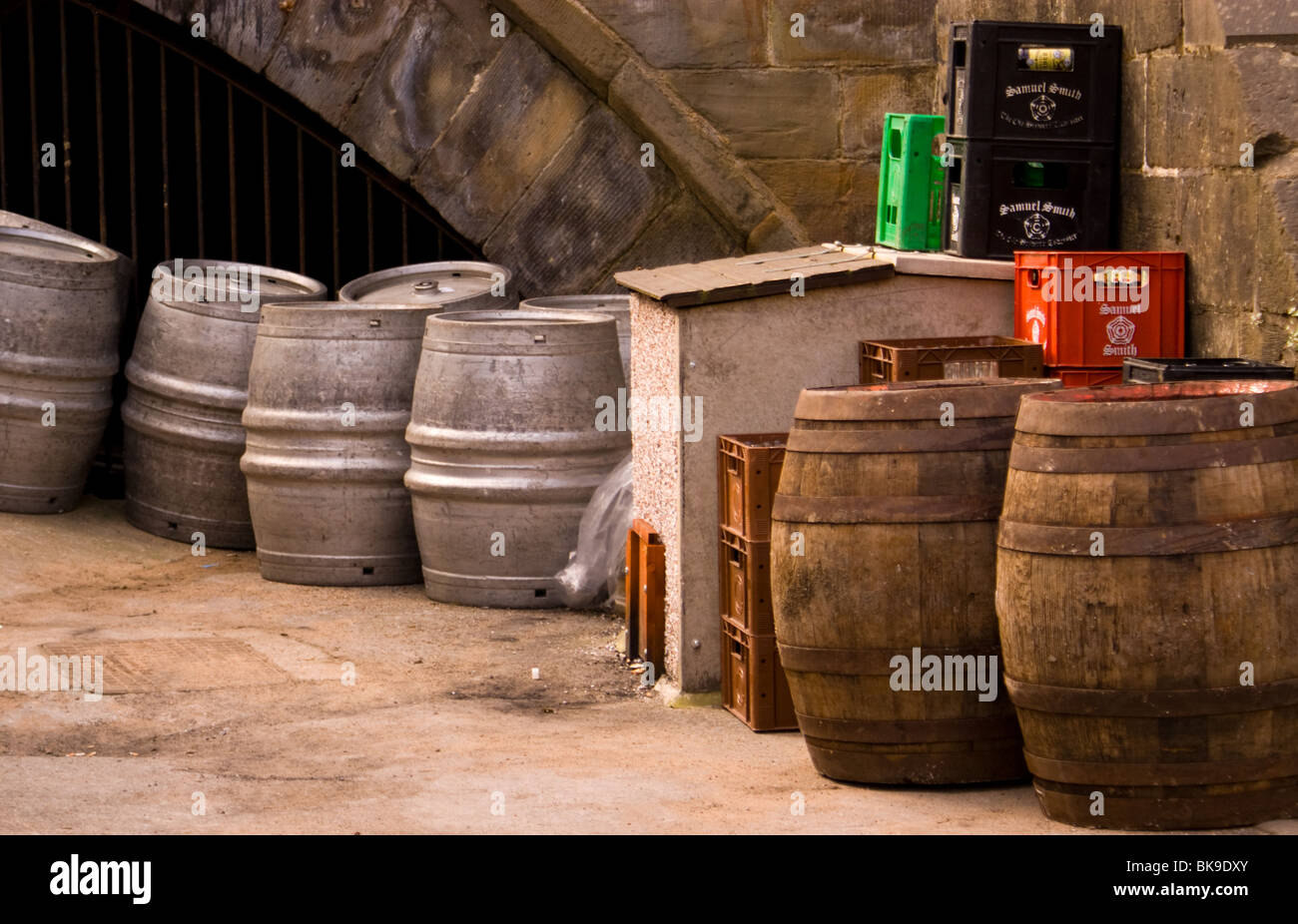 BEER KEGS AND METAL AND WOODEN BARRELS AND CRATES OUTSIDE A PUB IN ...
