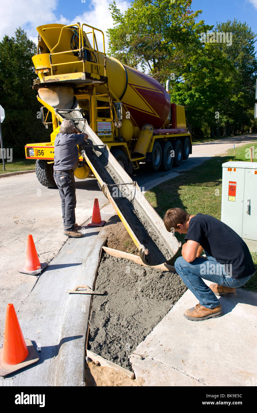 Cement workers work to repair roadway Stock Photo - Alamy