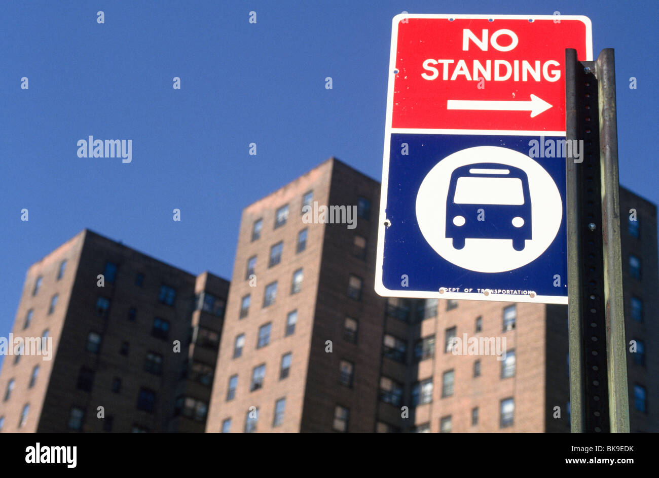 Bus stop sign with residential buildings in background Stock Photo - Alamy
