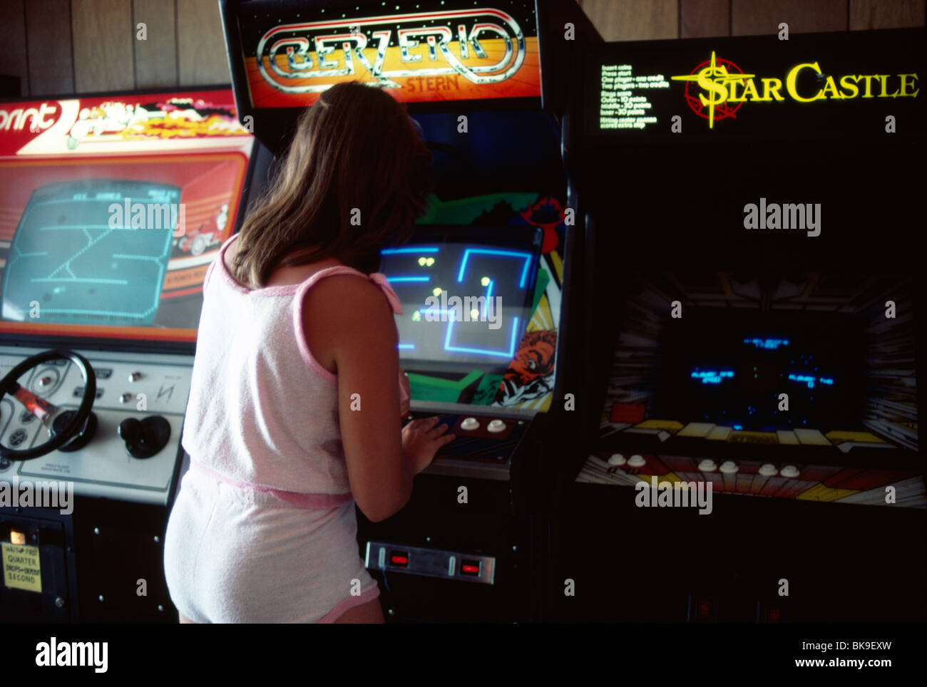 Woman playing games in amusement arcade Stock Photo - Alamy