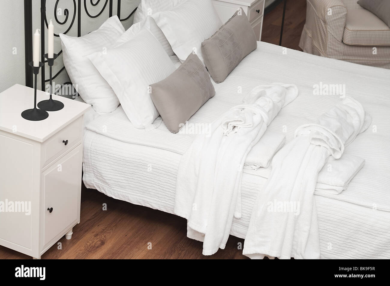 Two terry white dressing gowns on a bed in a bedroom Stock Photo - Alamy