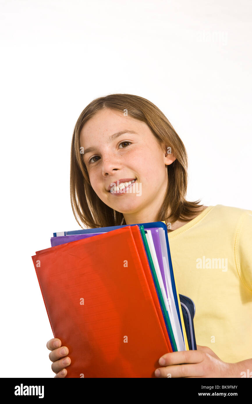 Portrait of a smiling girl with a stack of exercise books Stock Photo ...