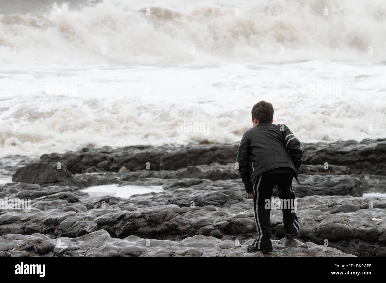 Lewis rock hopping amongst the Atlantic breakers on the beach at ...