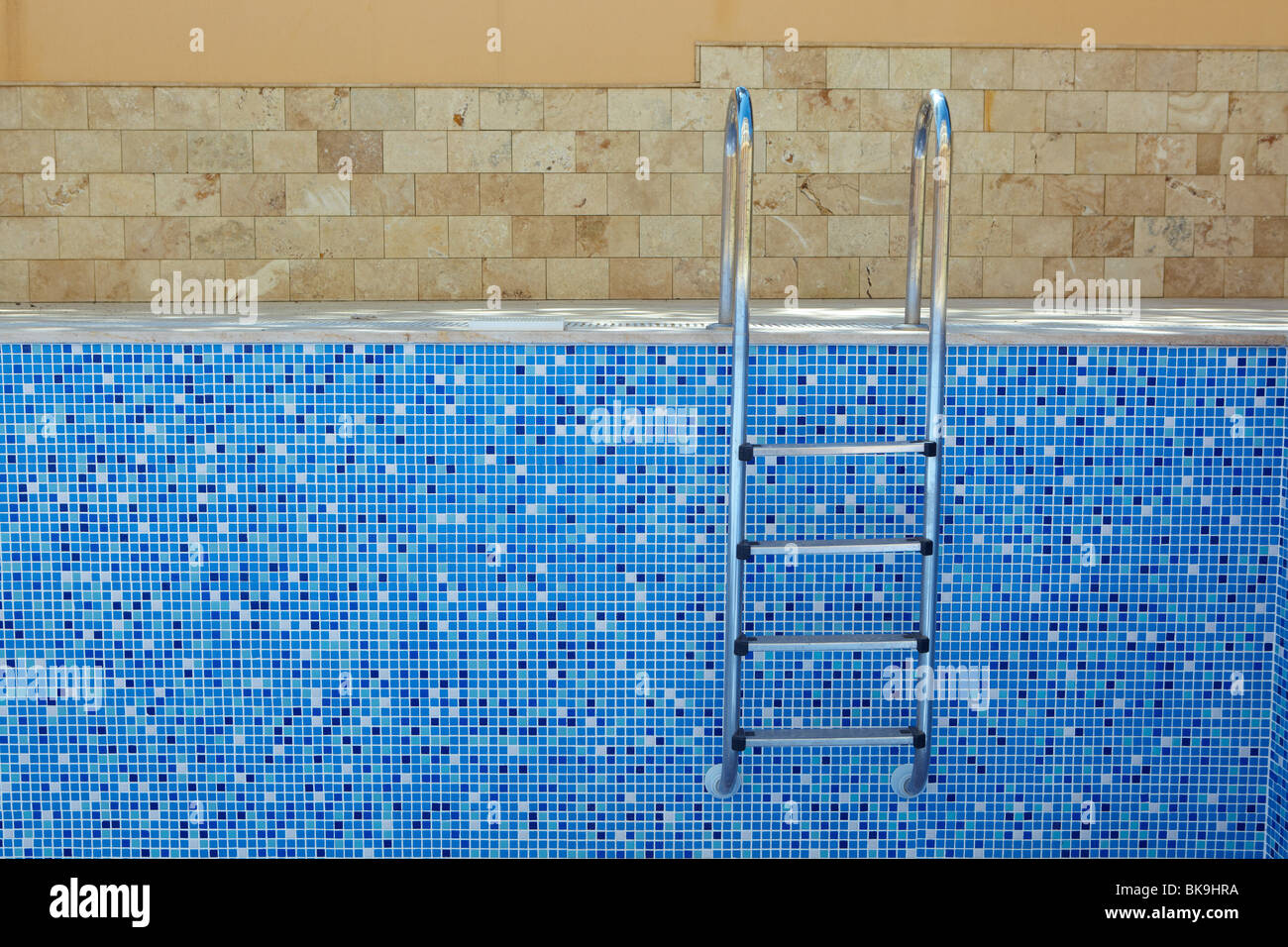Blue tiled empty swimming pool on a sunny day without water Stock Photo ...