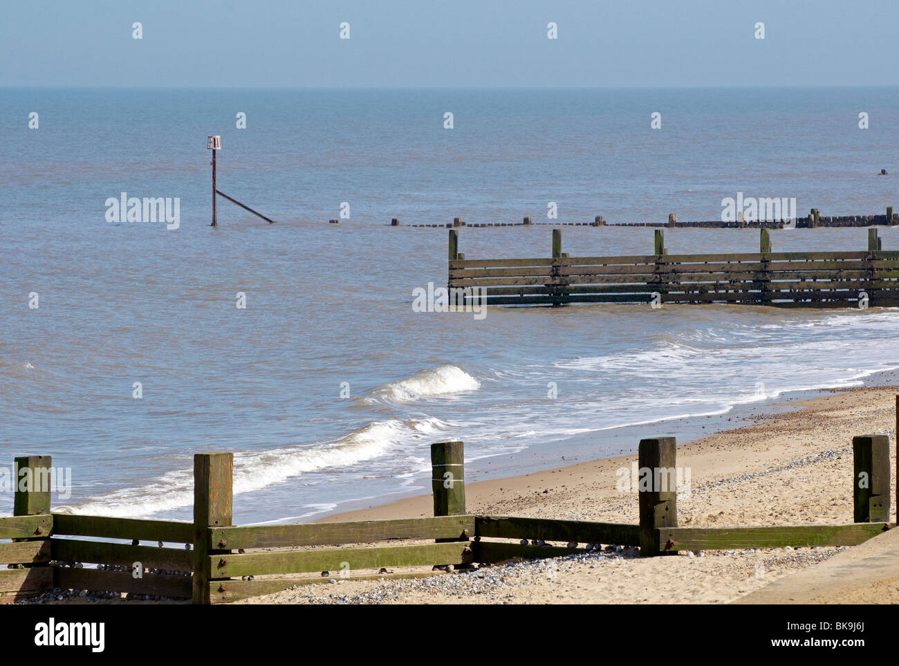 Timber groynes protecting the beach at Walcott, North Norfolk, England ...