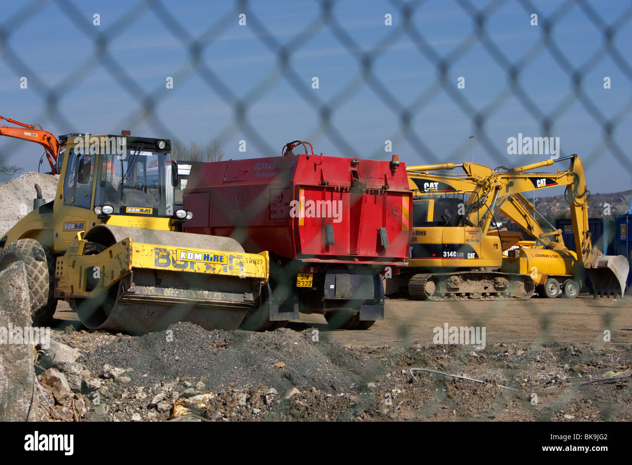 plant and equipment behind chain link security fence on construction ...