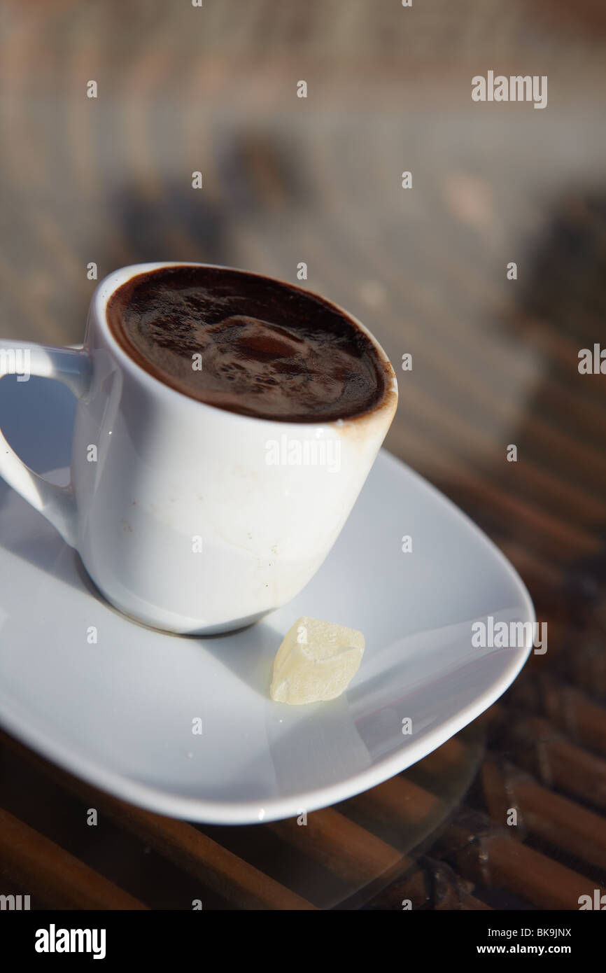 Real turkish coffee in a small white porcelain cup with a traditional ...