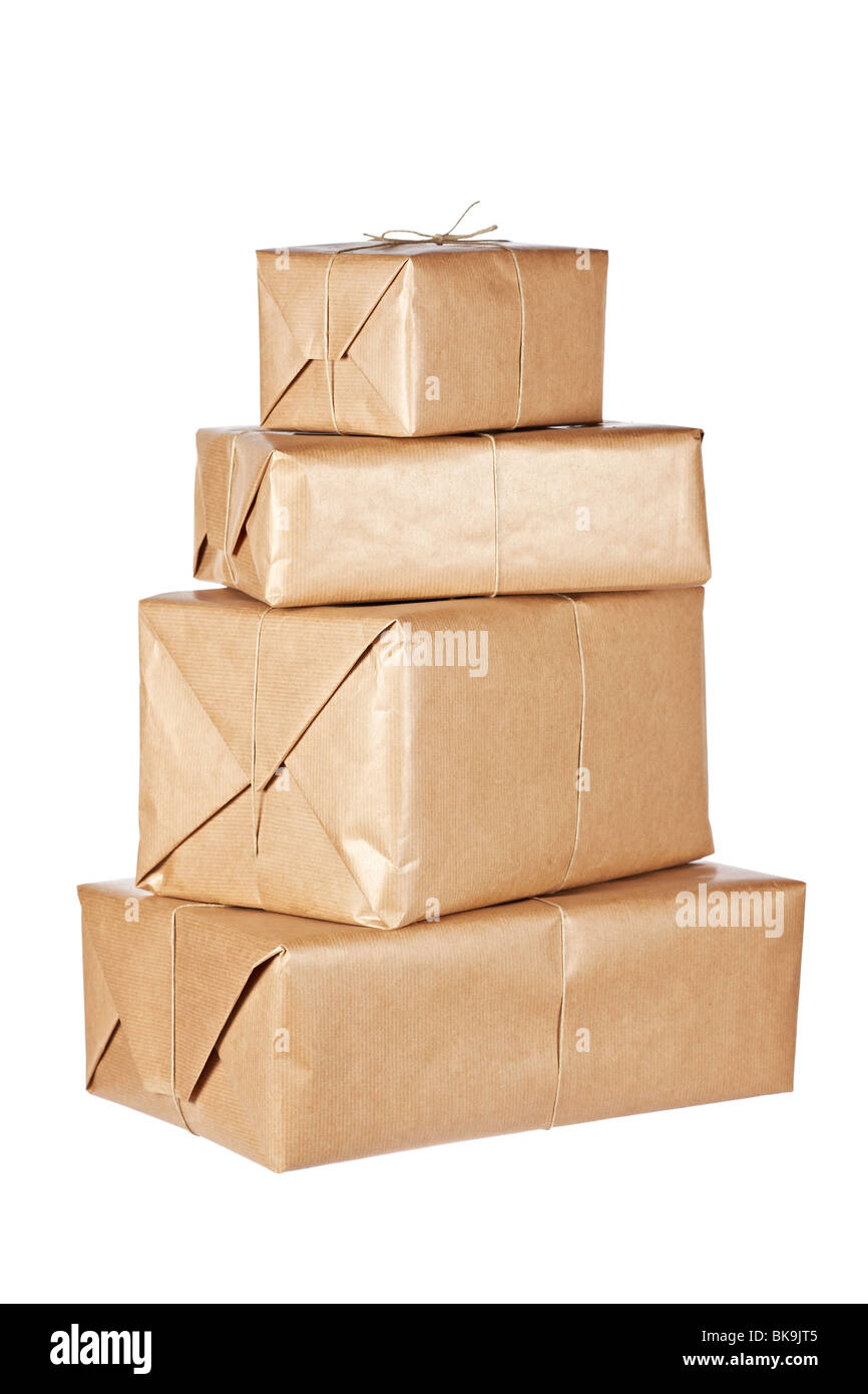 Stack of brown packages isolated on white background. Shallow depth of ...