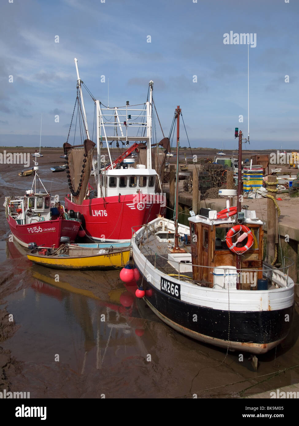 Fishing boats one with hanging beam trawl nets in the harbour at ...