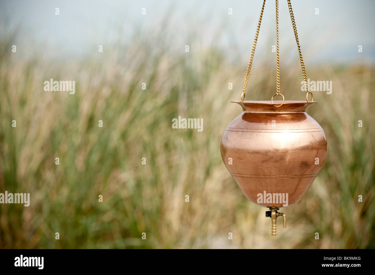 Shirodhara copper vessel hanging Stock Photo - Alamy
