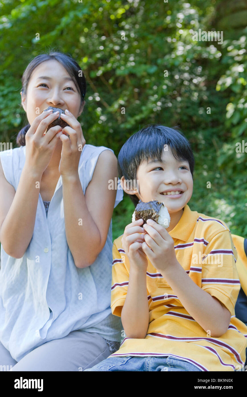 Mother and Son Eating Rice Ball Stock Photo - Alamy