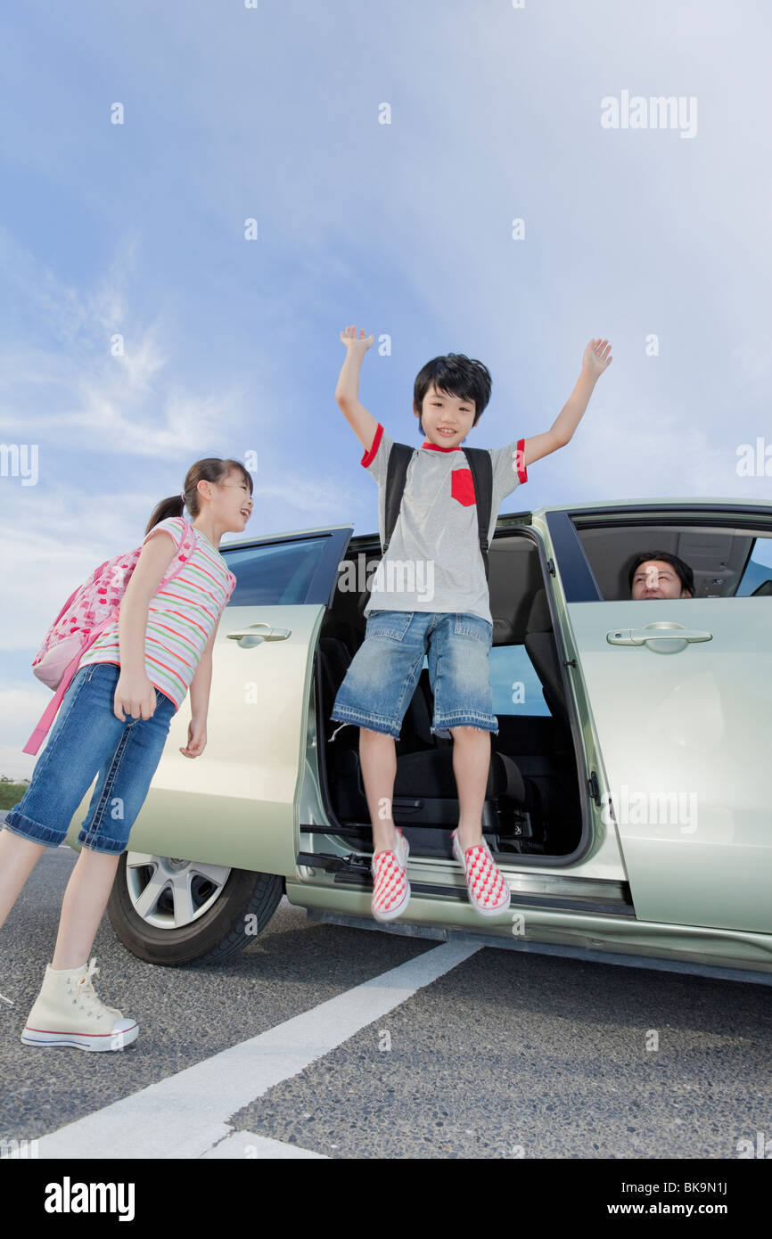 Boy Jumping Out of a Car Stock Photo - Alamy