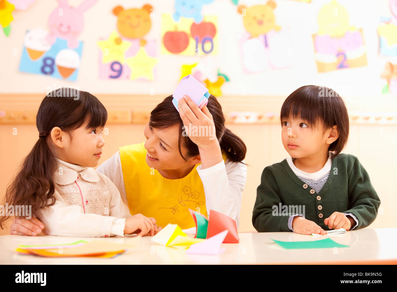 Nursery Teacher Talking to Children Stock Photo - Alamy