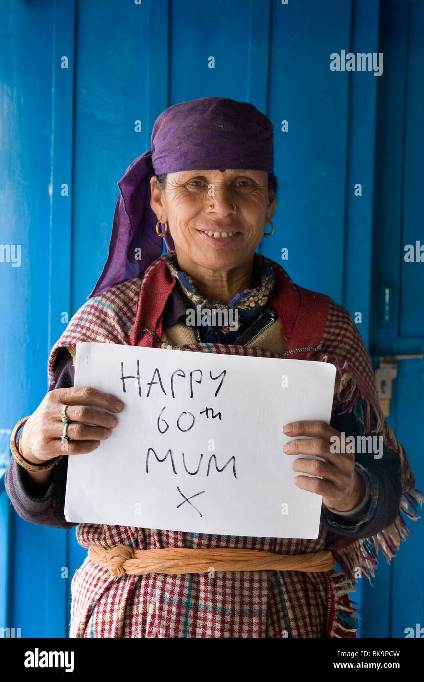 Lady in India holding a Happy 60th Mum sign Stock Photo - Alamy