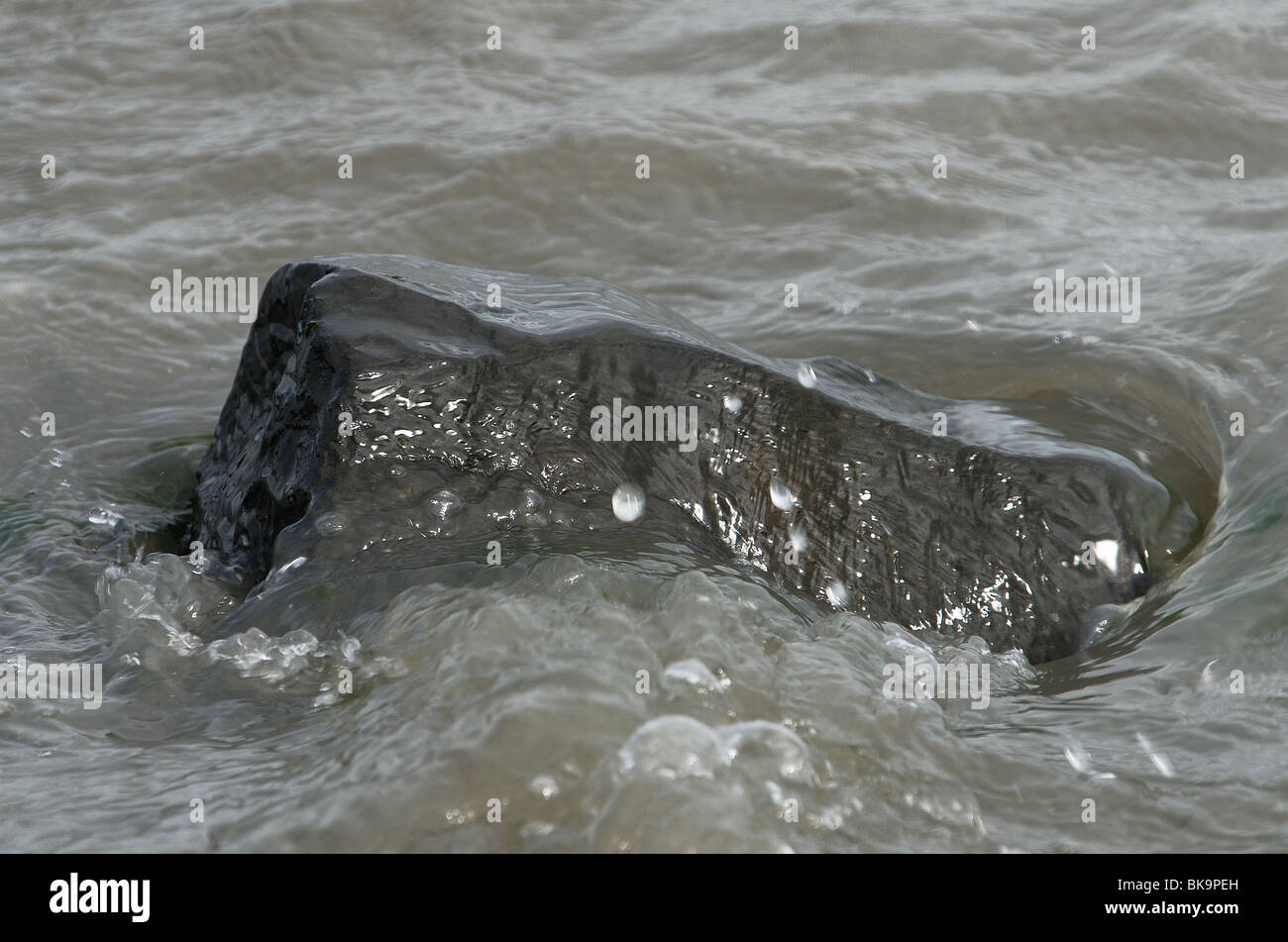 Stone with wave Stock Photo - Alamy