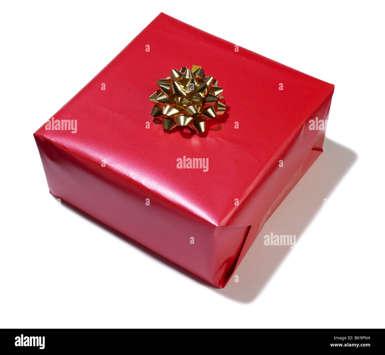 Red wrapped gift with gold bow Stock Photo - Alamy