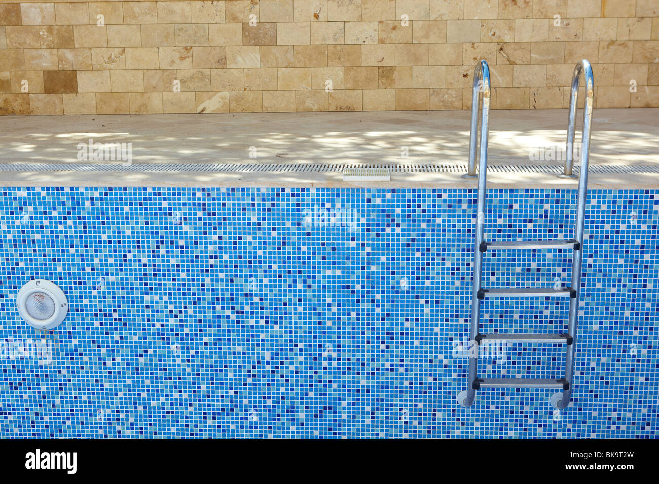 Blue tiled empty swimming pool on a sunny day without water Stock Photo ...