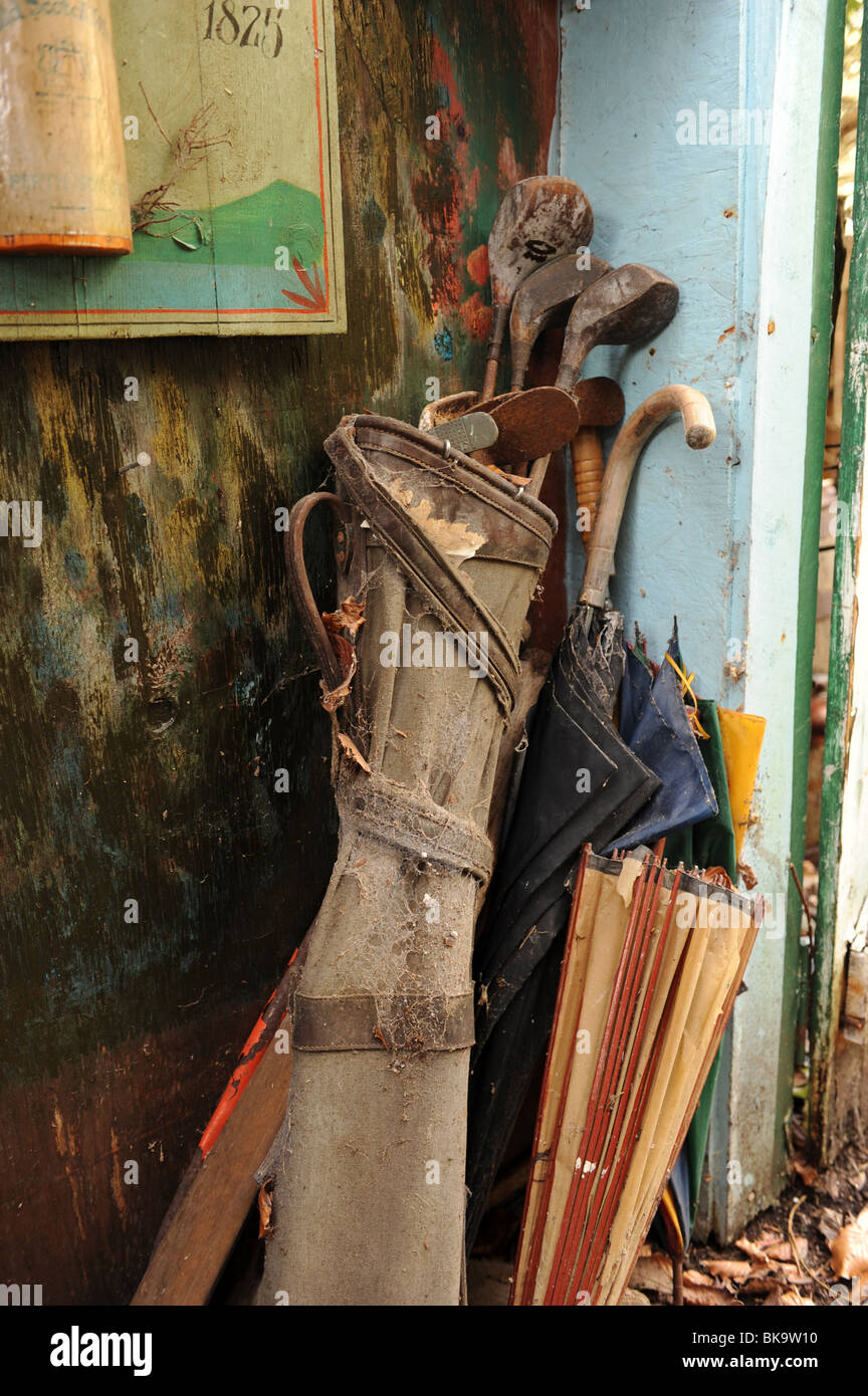 Set of dusty old discarded golf clubs in a garden shed Stock Photo - Alamy