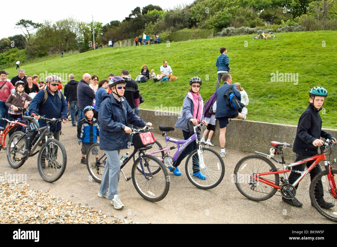 A group cyclists walking their push bikes on a footpath Stock Photo - Alamy