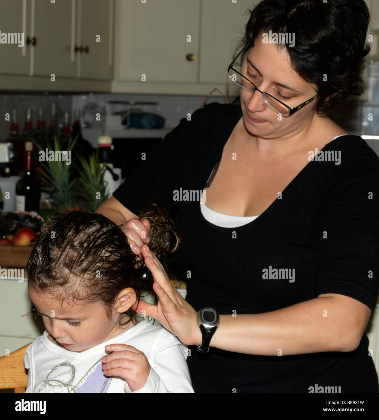 Mother Using Hedrin Treatment For Daughters Head Lice Stock Photo - Alamy