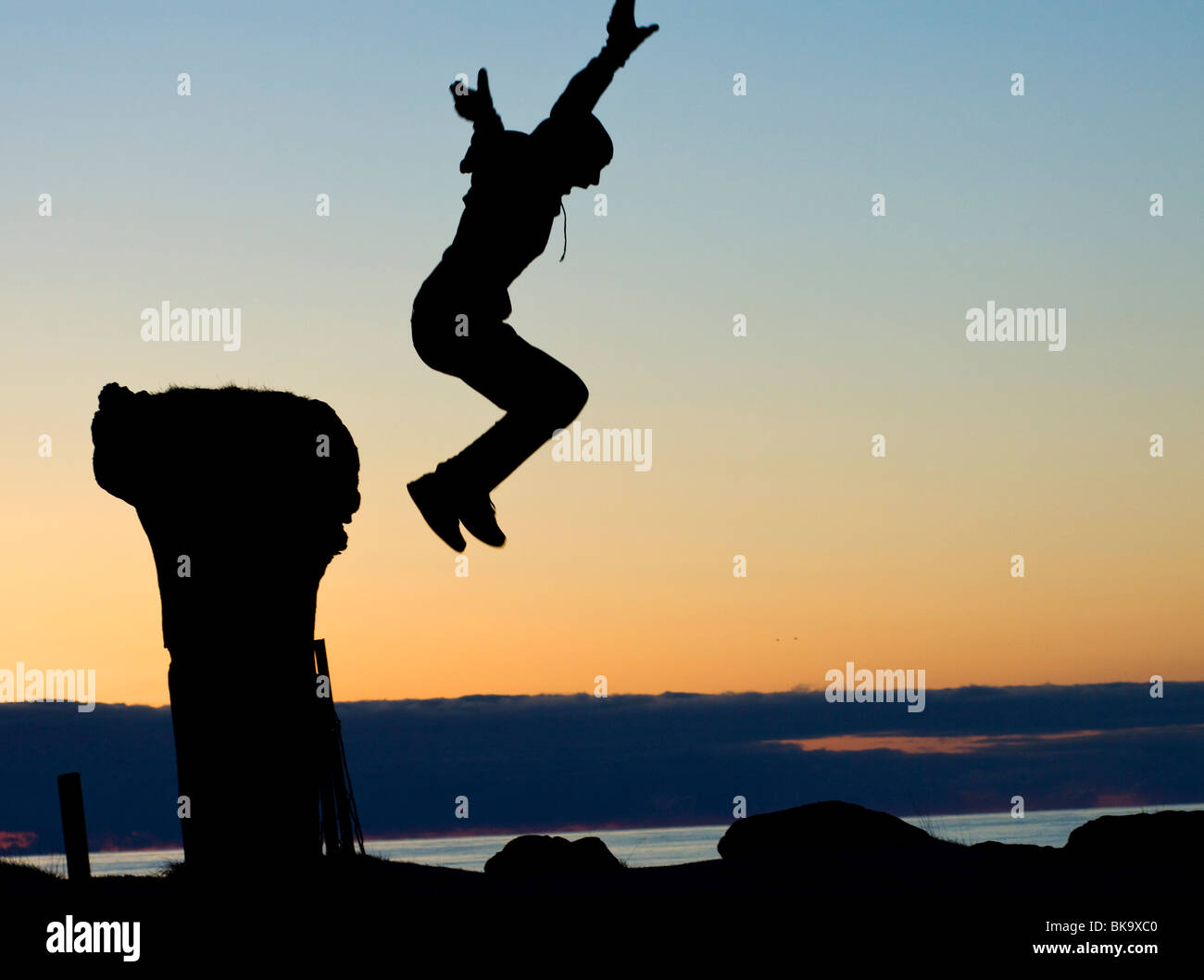 Jumping boy on the beach Stock Photo - Alamy