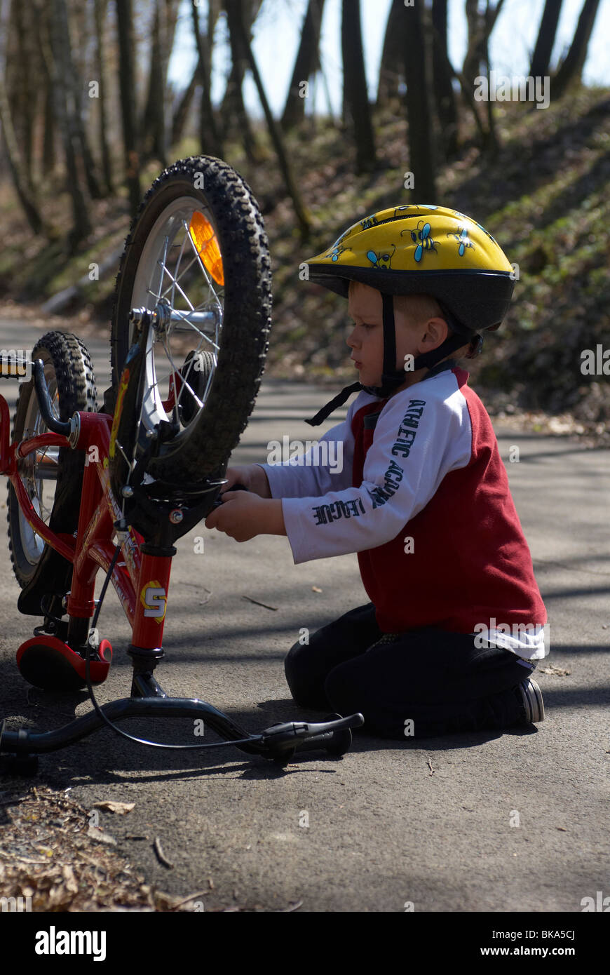 Boy Learning to Ride Bicycle with stabilizing wheel bike Stock Photo ...