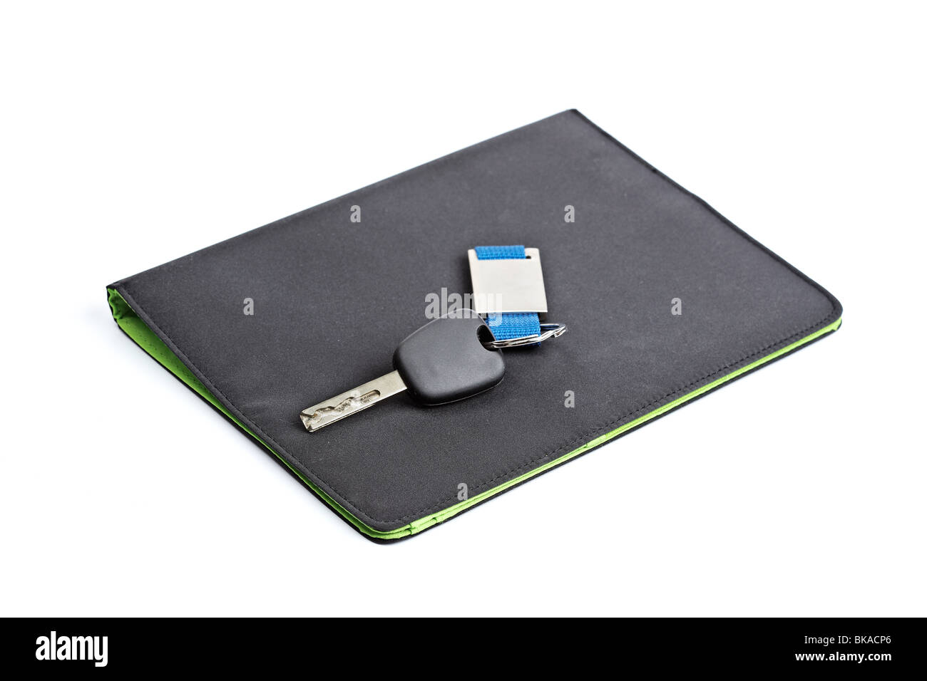 Car key and black folder isolated on white background with shallow ...