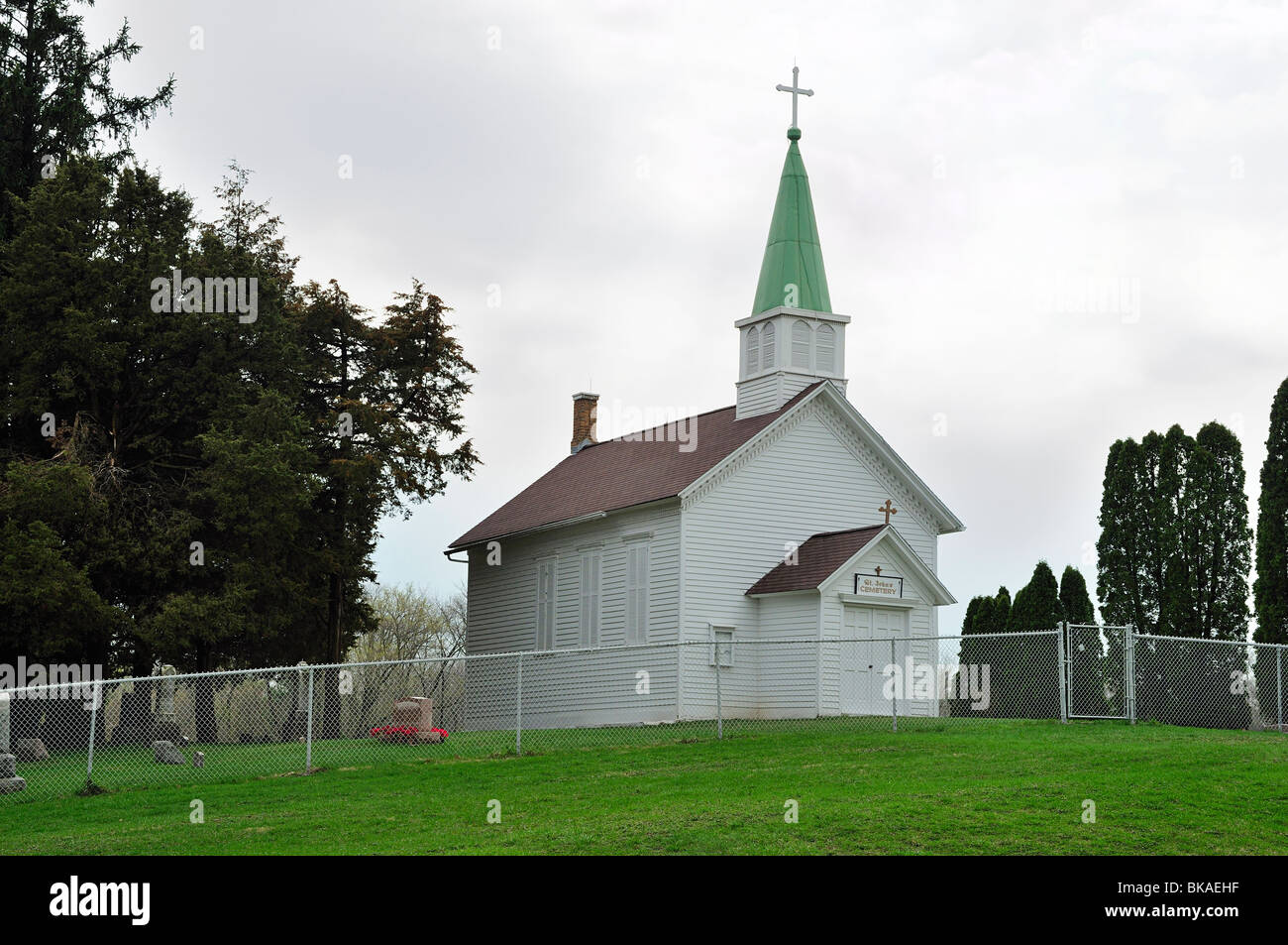 Tiny Catholic church and cemetery on hillside in small town USA Stock ...