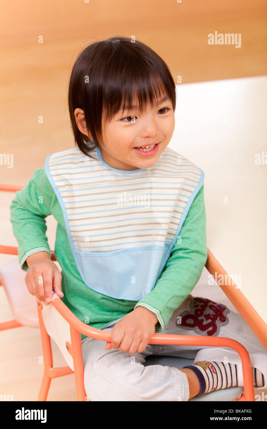 Boy Sitting on Chair Stock Photo - Alamy