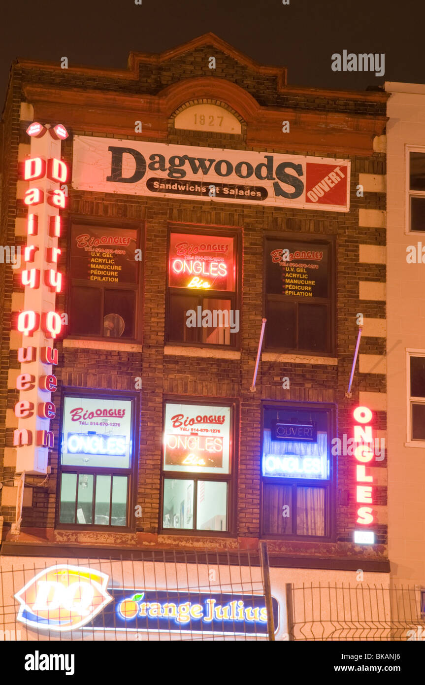 Building with neon signs at night time Stock Photo - Alamy